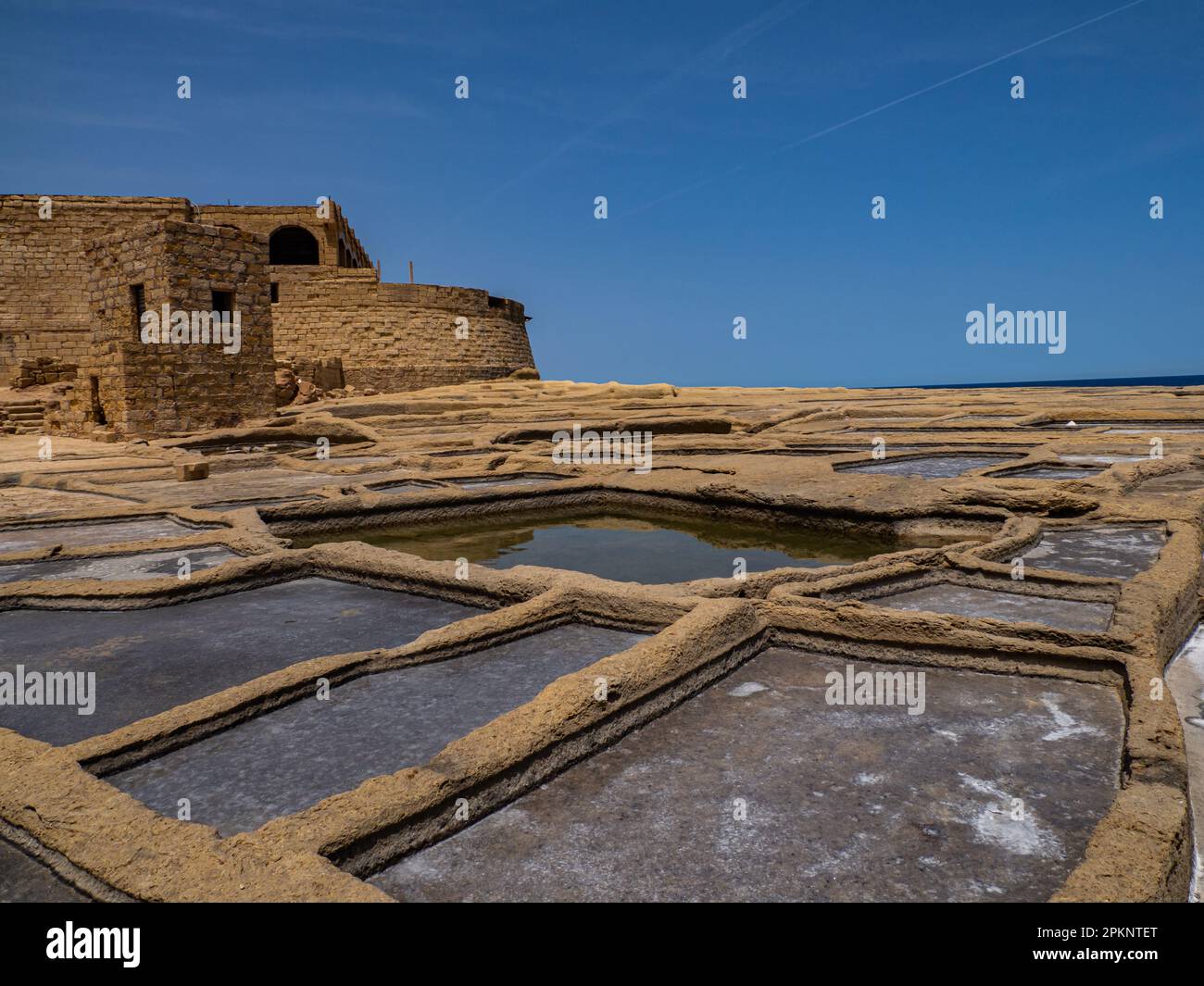 Salt evaporation ponds on the coast of the island of Gozo also called ...