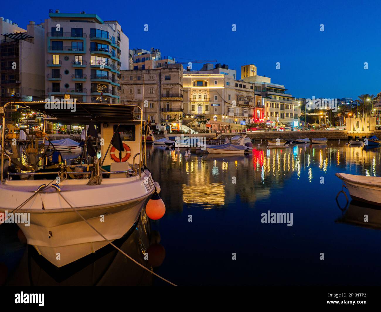 St Julian, Malta - May, 2021: Spinola bay with plenty of colorful boats ...