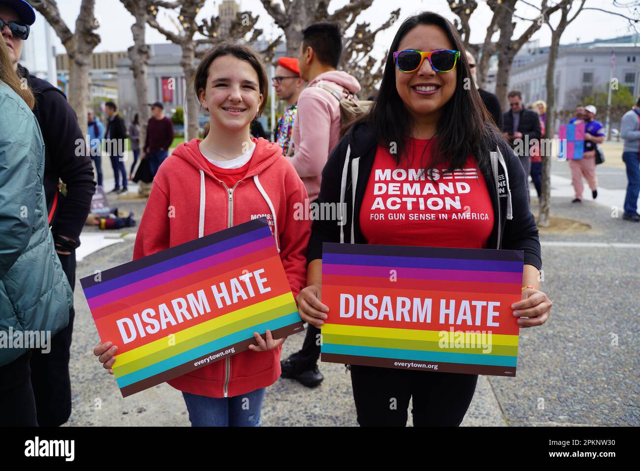 Protesters hold placards that says "Disarm hate" during the march ...