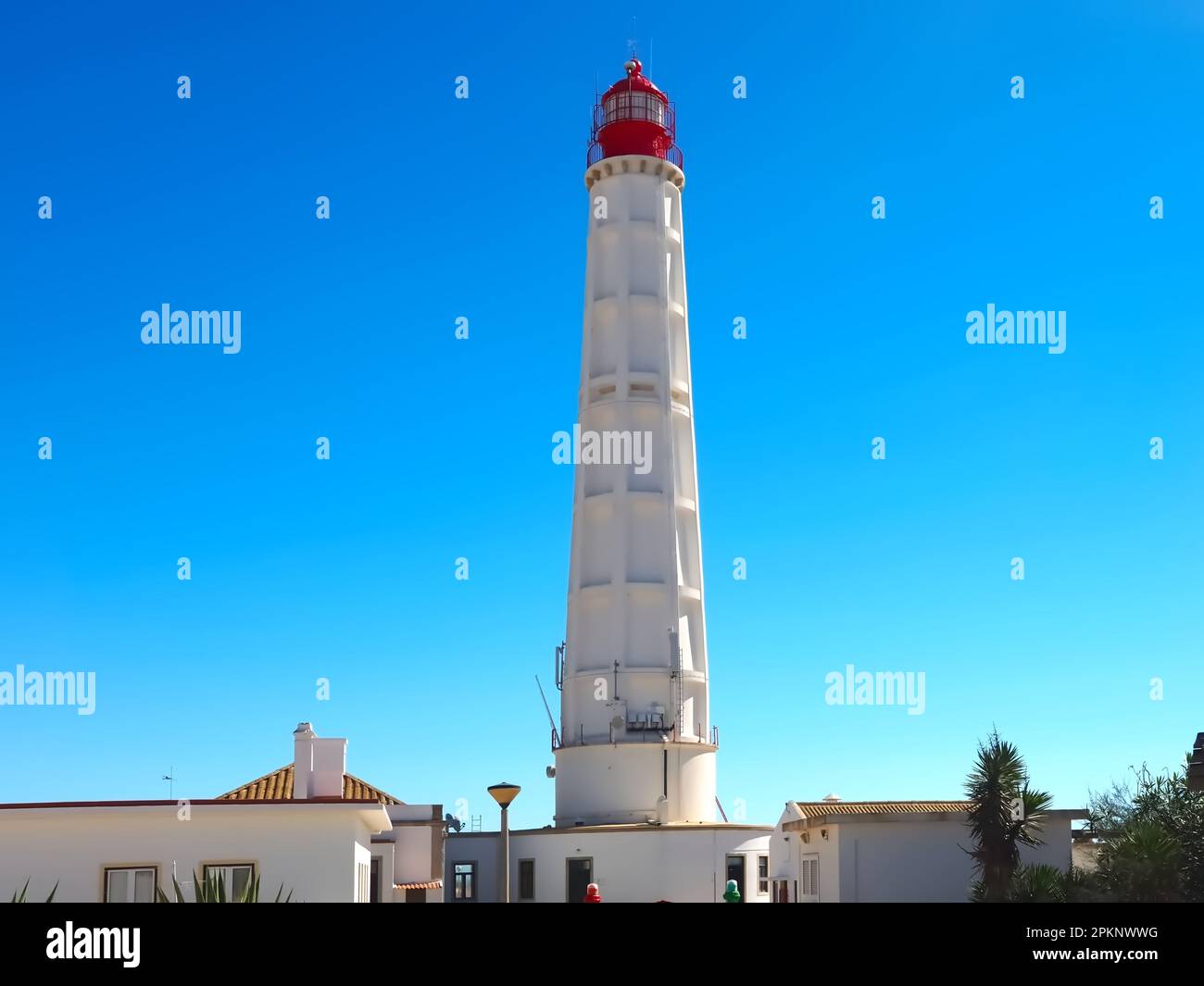 Lighthouse of the island Farol at the Algarve coast of Portugal Stock ...