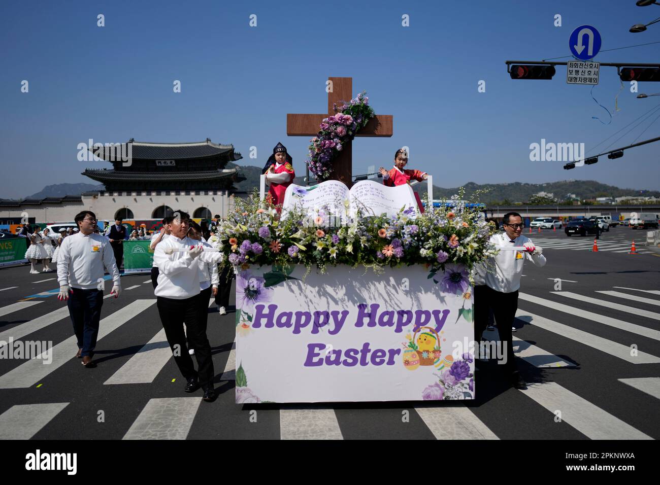 Participants carry a cart with a cross during the Easter parade near ...