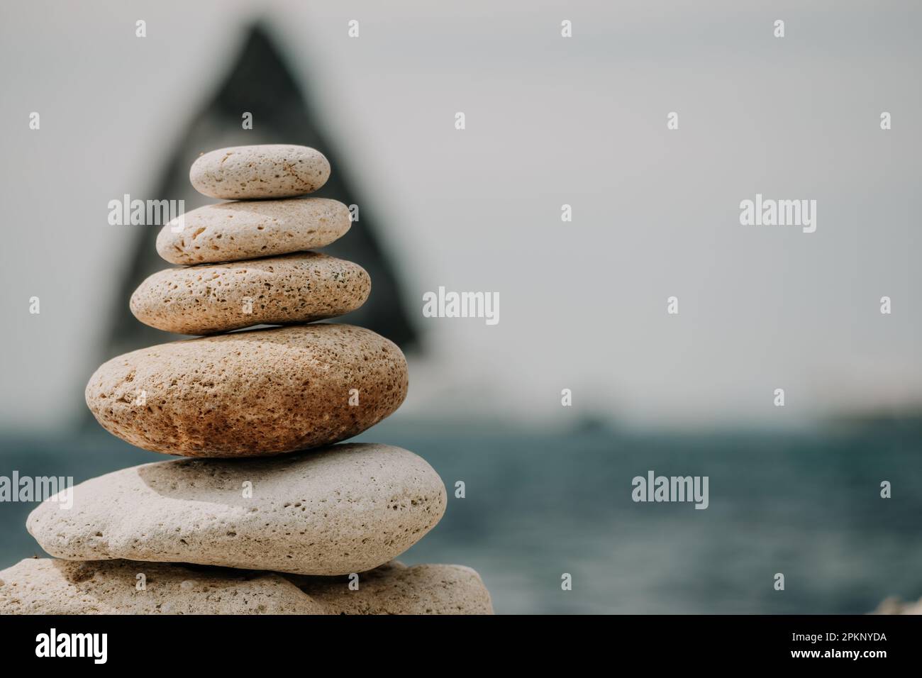 balanced rock pyramid on the pebbled beach is a study in harmony and ...