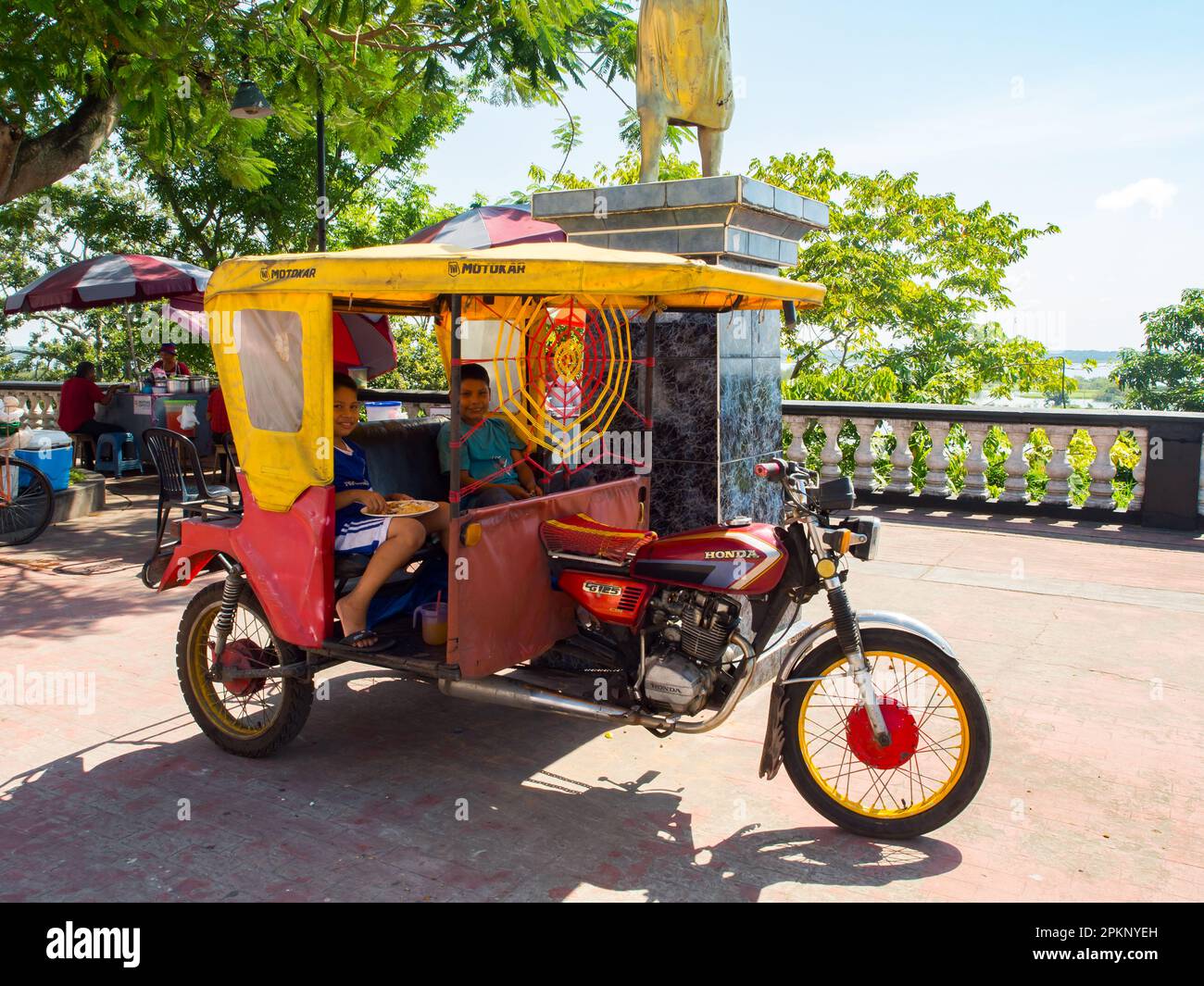 Iquitos, Peru - Dec, 2017: Colorful rickshaw wait for passengers in the ...