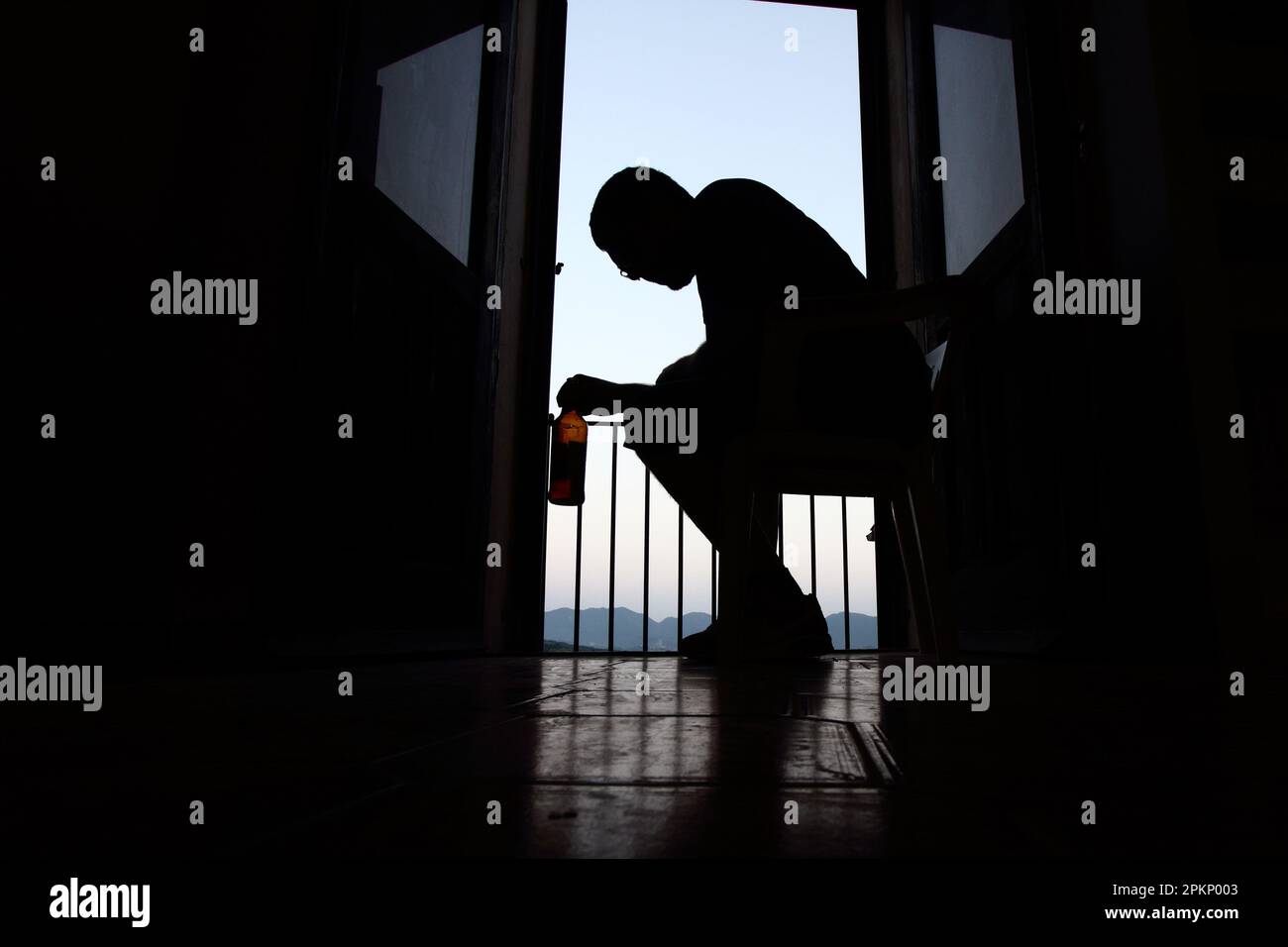 alcoholism - backlight man with bottle of wine Stock Photo - Alamy