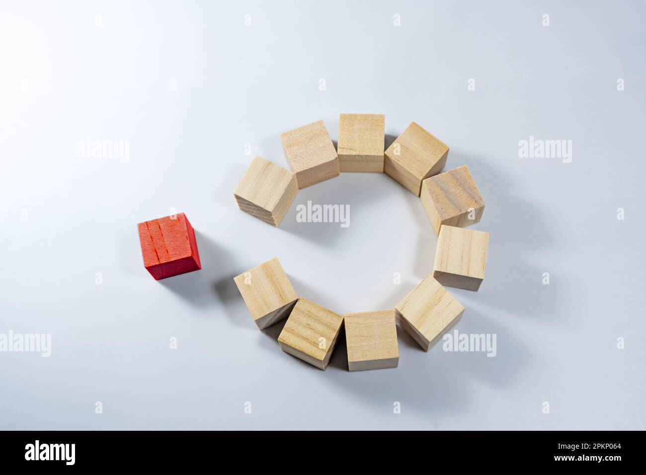 Natural colored wooden cubes, together form a circle with a gap, one ...