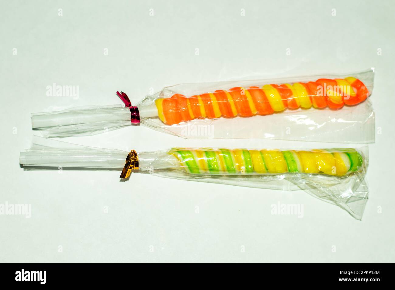 A multi-color chocolate lollipop with either a fizzy or gummy sweets ...