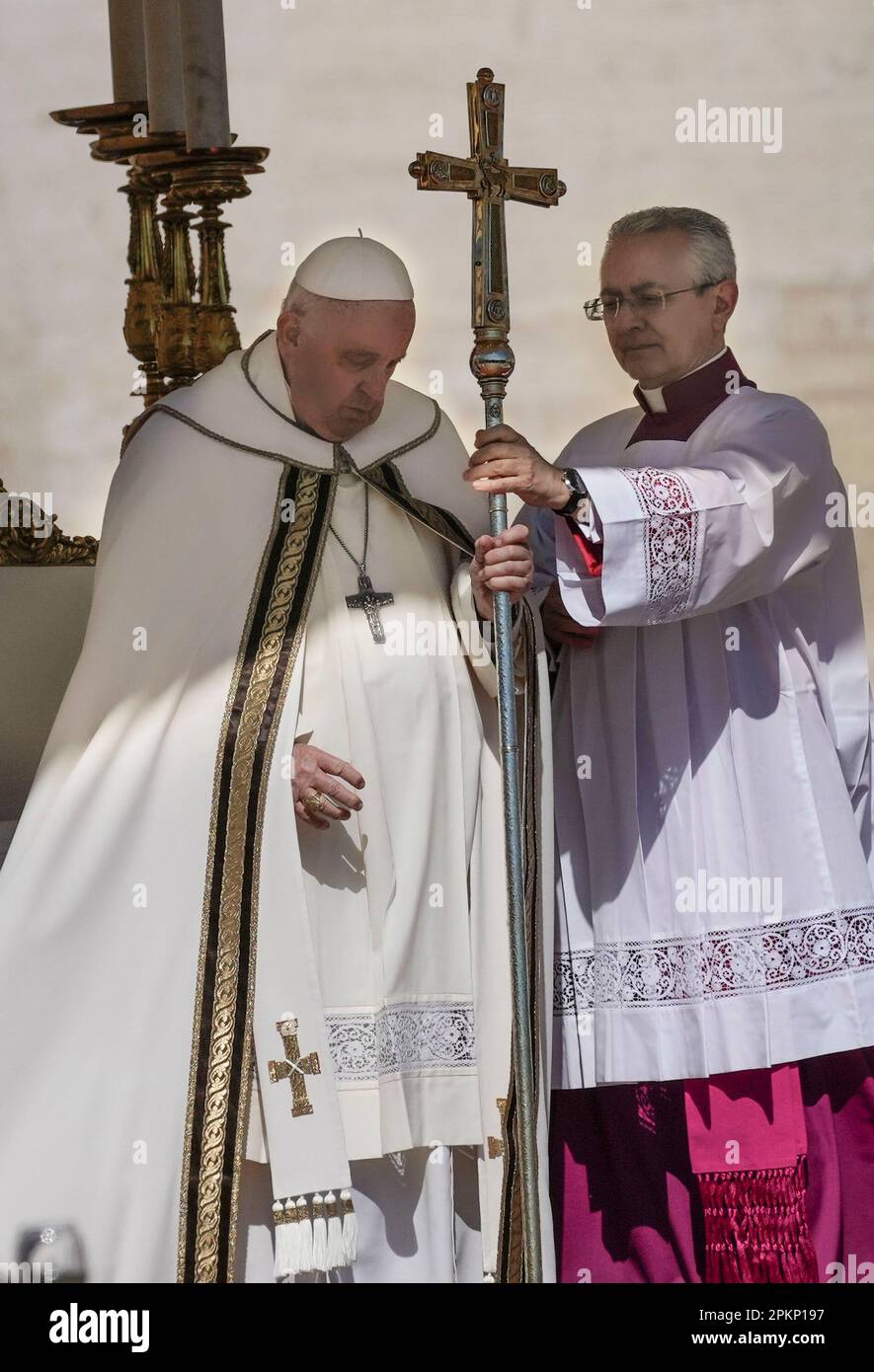 Pope Francis, left, is assisted by his aide Diego Ravelli on the altar ...