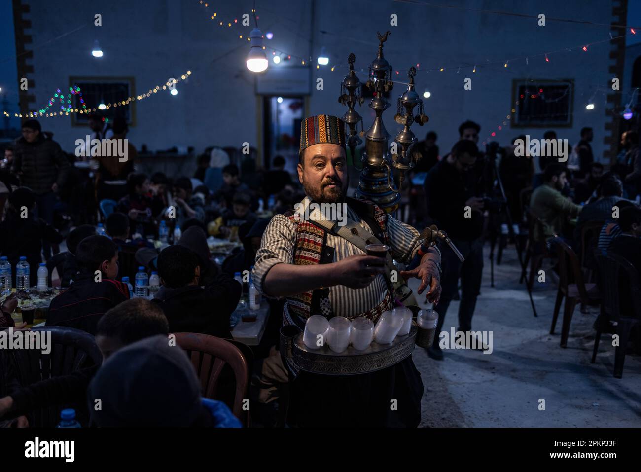08 April 2023, Syria, Idlib: A liquorice juice vendor serves a mass ...
