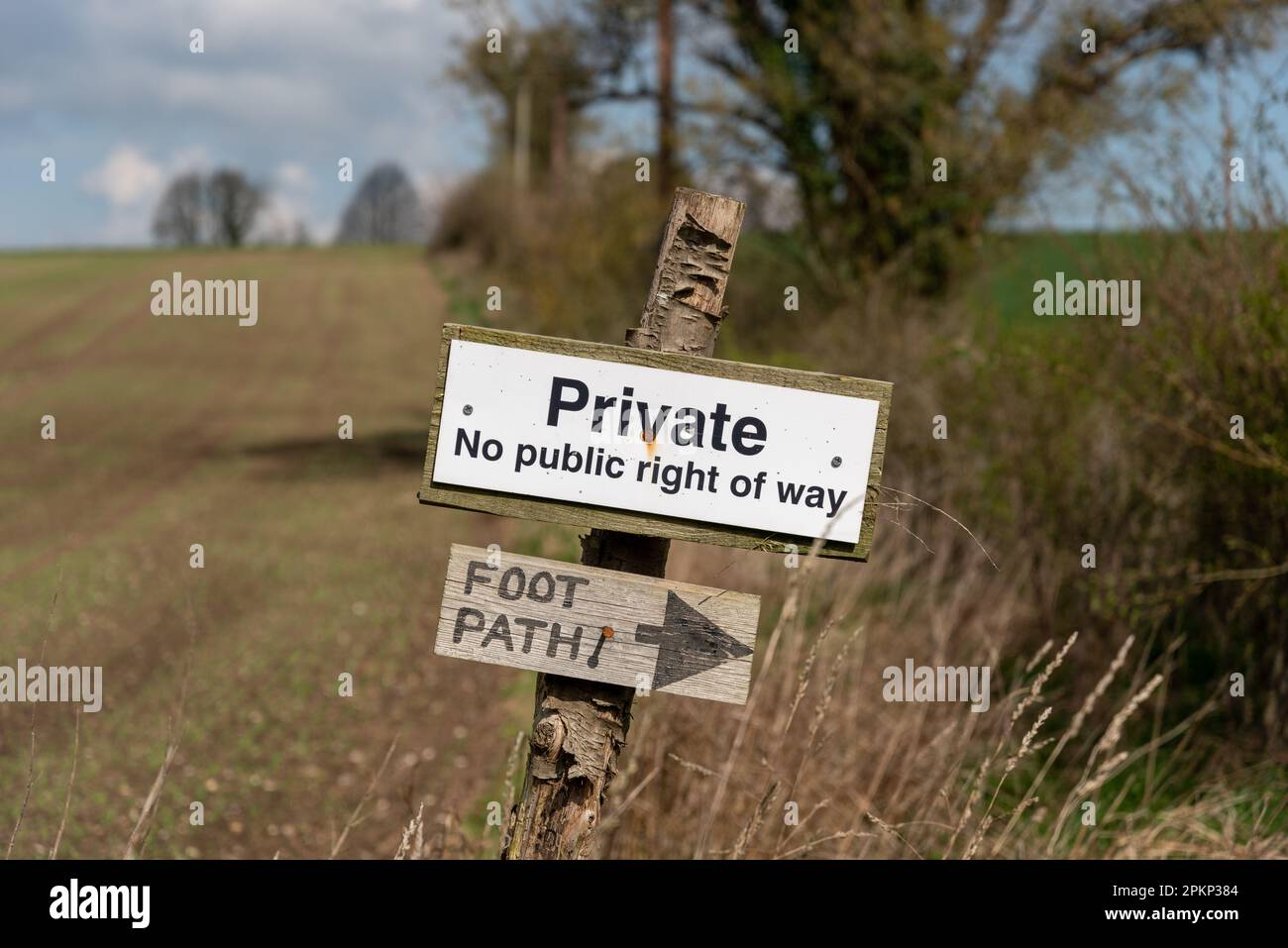 Wooden signpost in the English countryside showing footpath and right ...