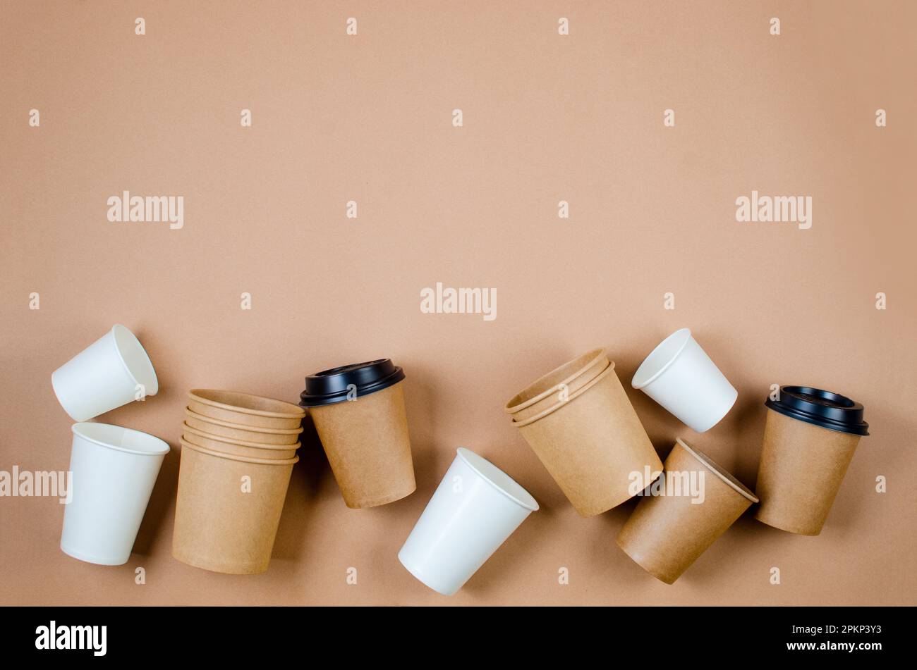 Top view on different eco-friendly disposable paper cups on beige ...