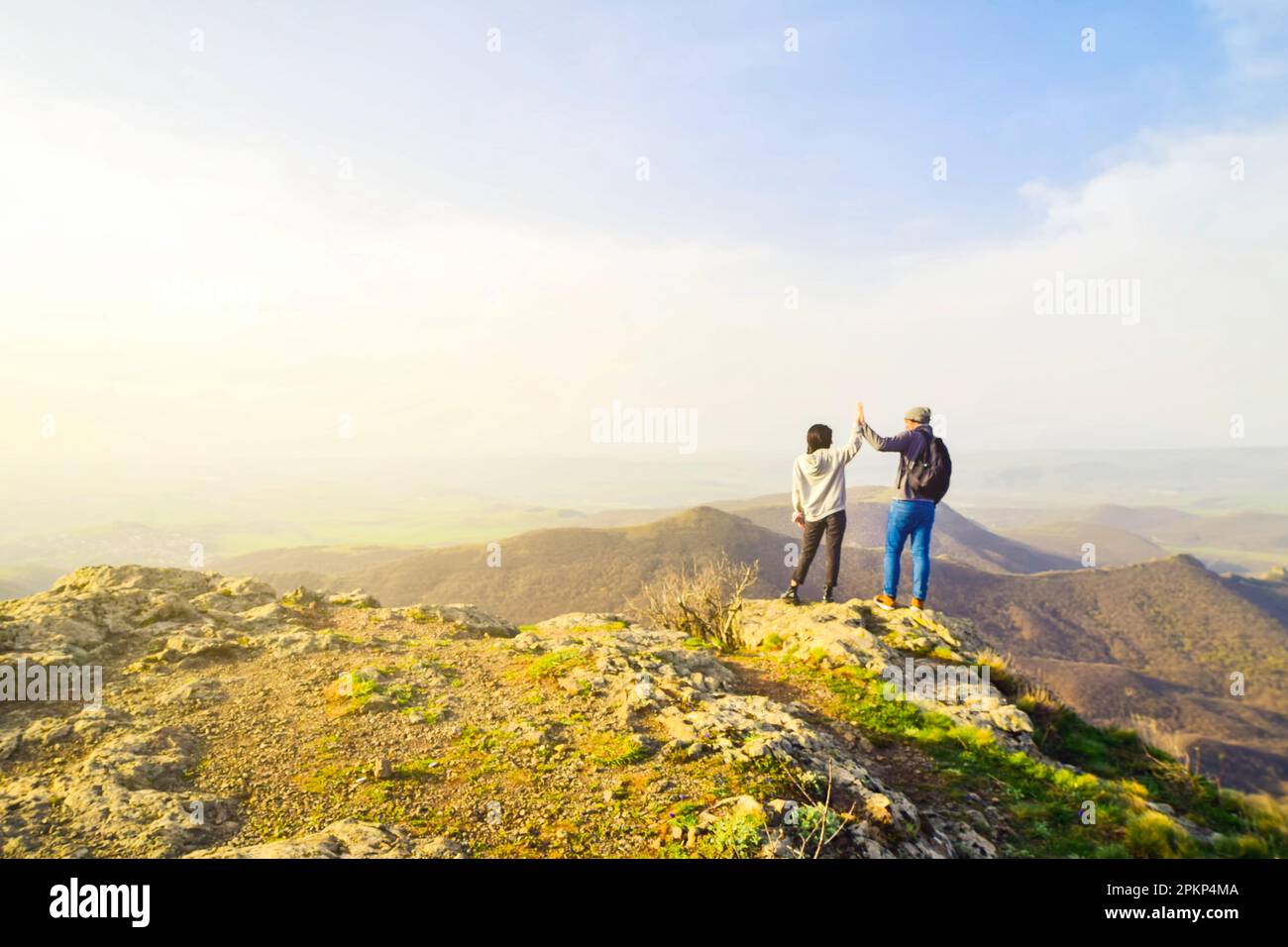 Caucasian young travelous couple enjoy mountain top viewpoint panorama ...
