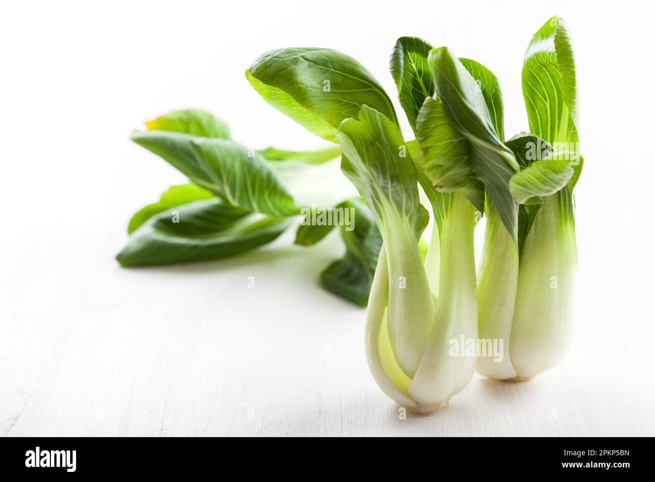 Chinese cabbage pak choi on wooden table Stock Photo - Alamy