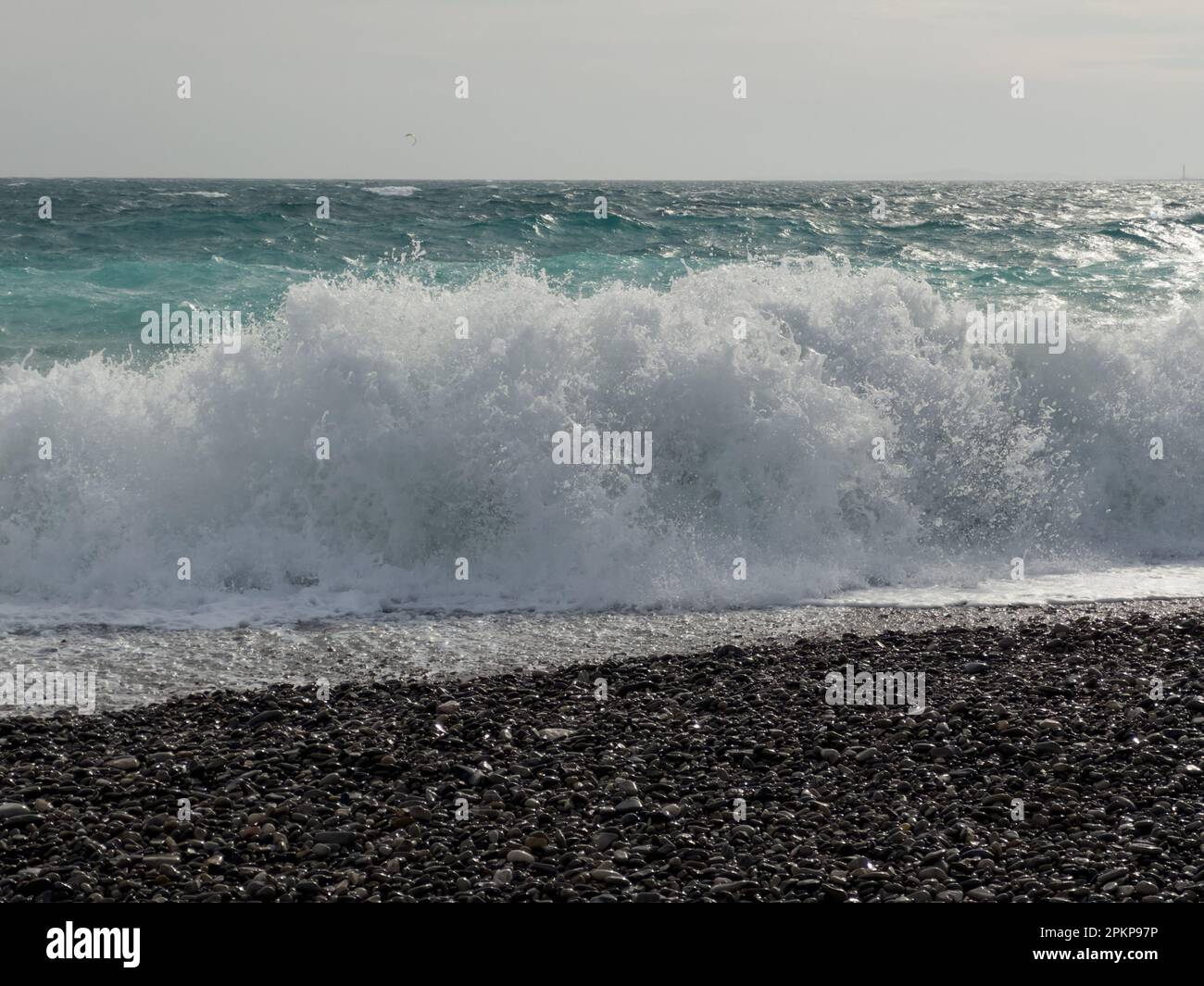 Pebble beach of Nice, France with azure waves of mediterranean sea ...