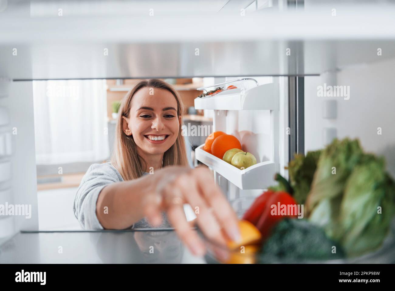 Woman taking food from refrigerator hi-res stock photography and images ...