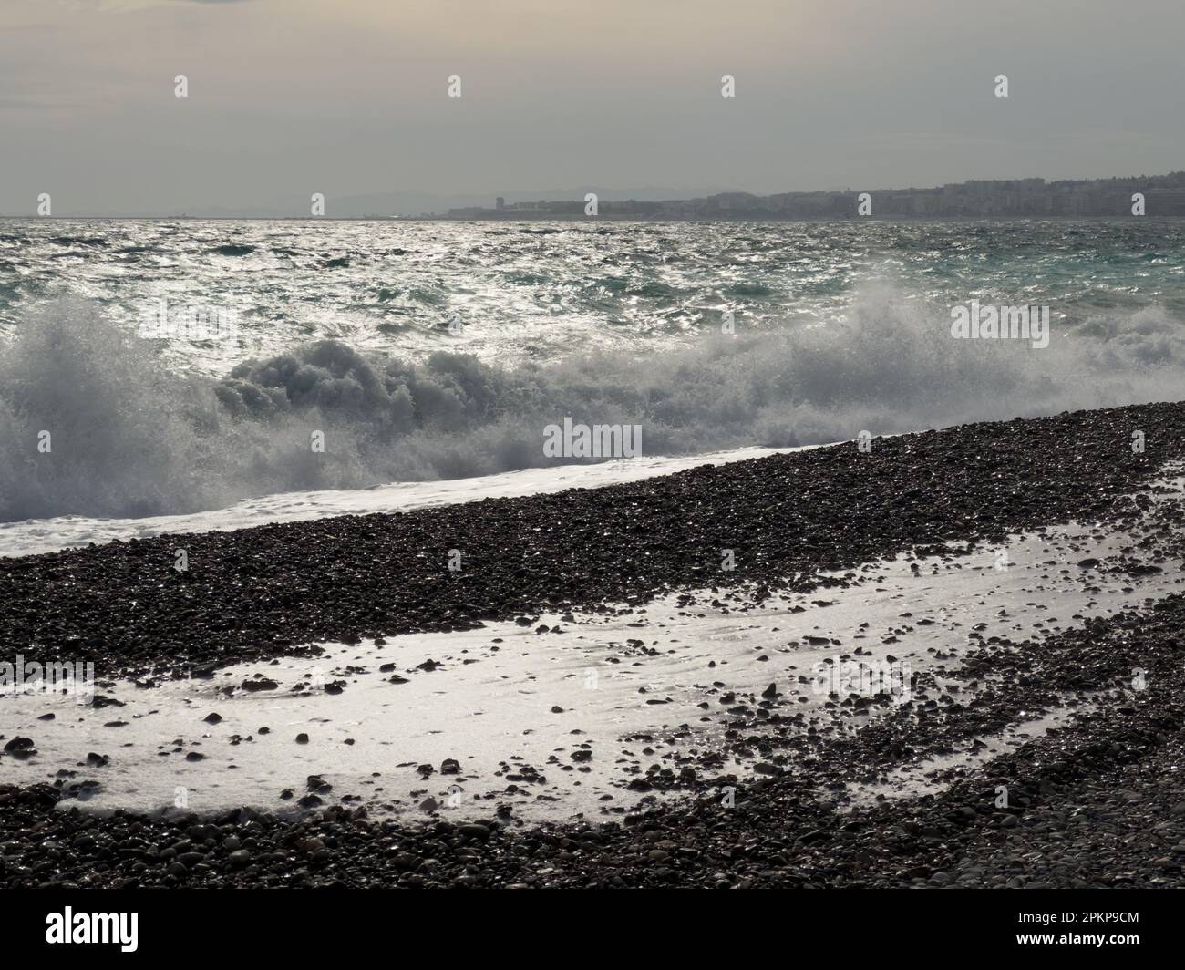 Pebble beach of Nice, France with azure waves of mediterranean sea ...