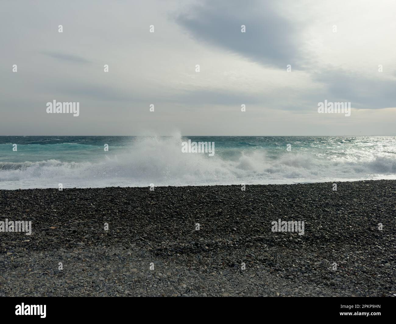 Pebble beach of Nice, France with azure waves of mediterranean sea ...