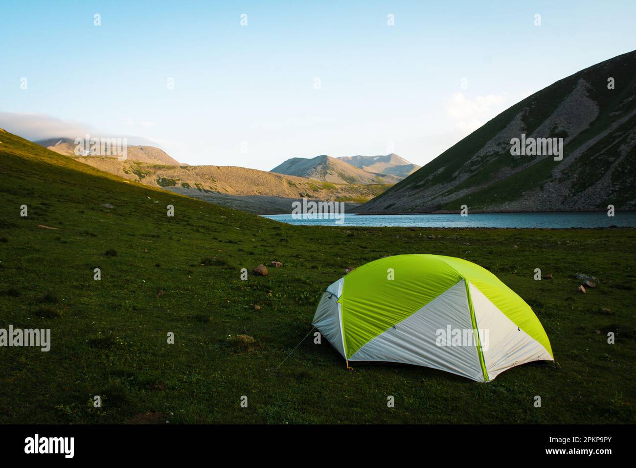 Green tent view panorama with Levanis lake in Georgia. Tranquil camping ...