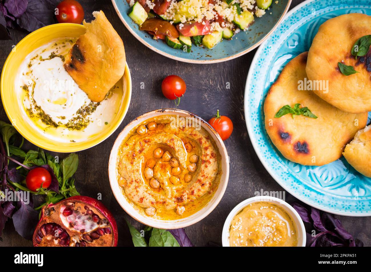 Table served with middle eastern traditional vegetarian dishes. Hummus ...