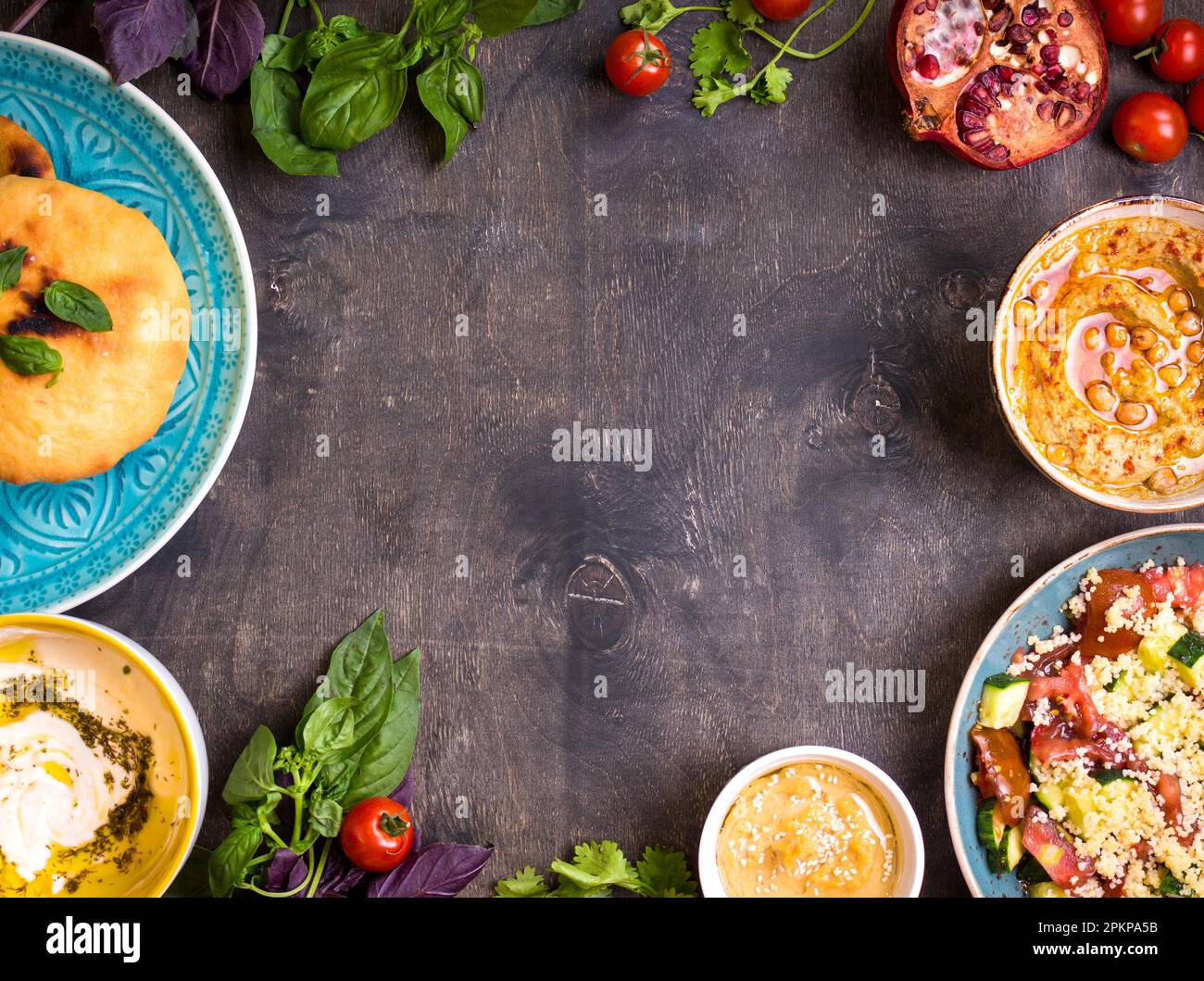 Table served with middle eastern traditional vegetarian dishes. Hummus ...