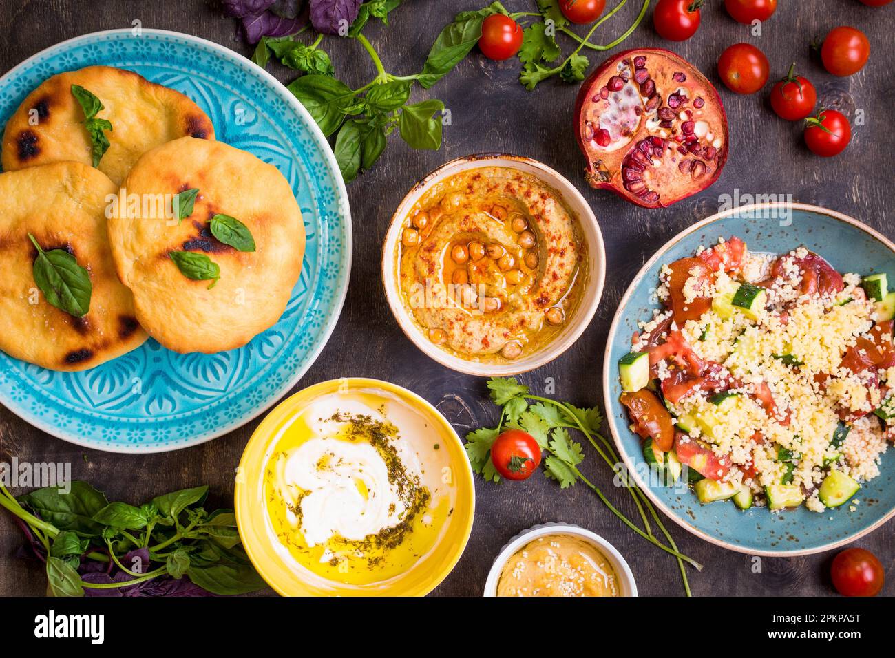 Table served with middle eastern traditional vegetarian dishes. Hummus ...