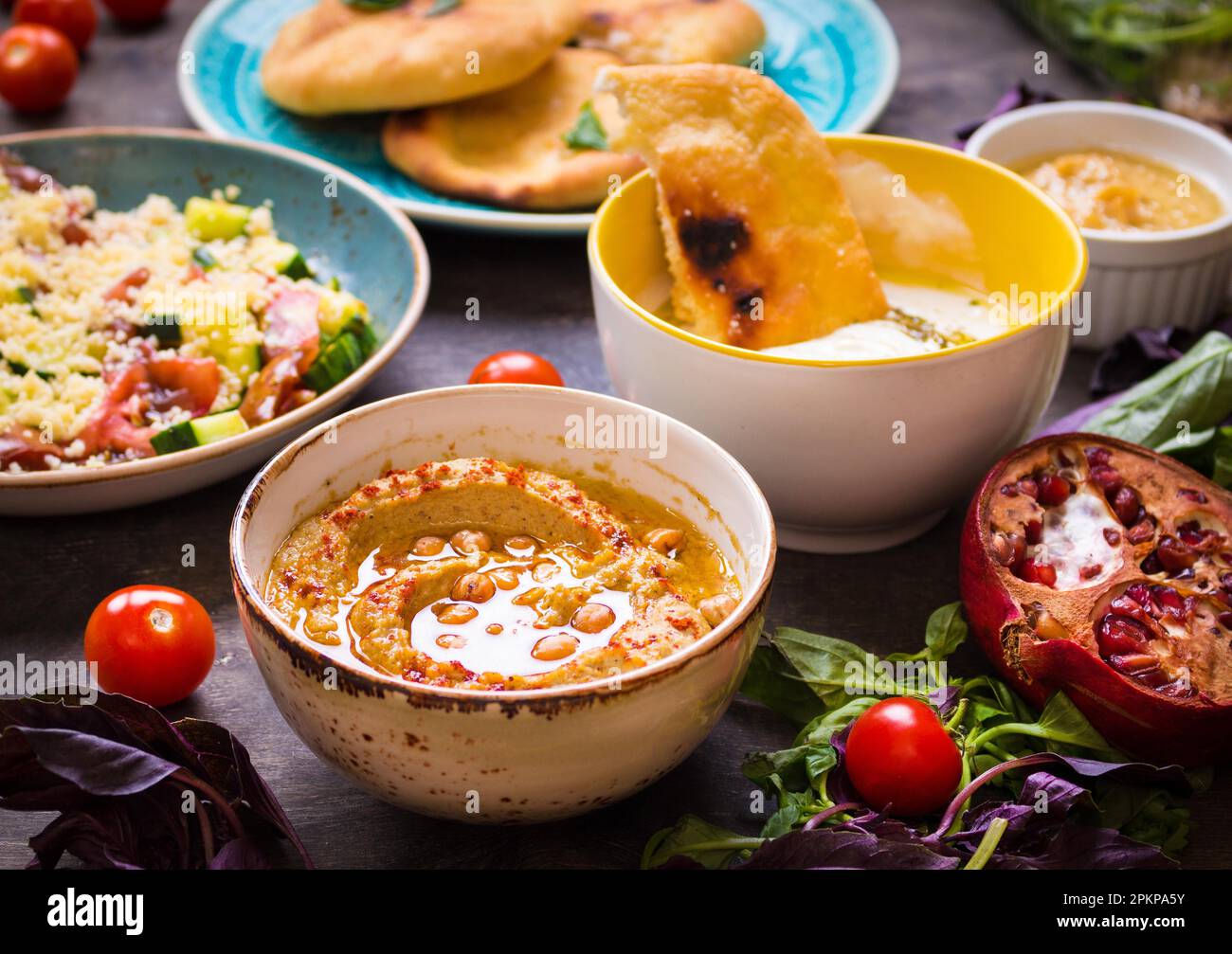 Table served with middle eastern traditional vegetarian dishes. Hummus ...