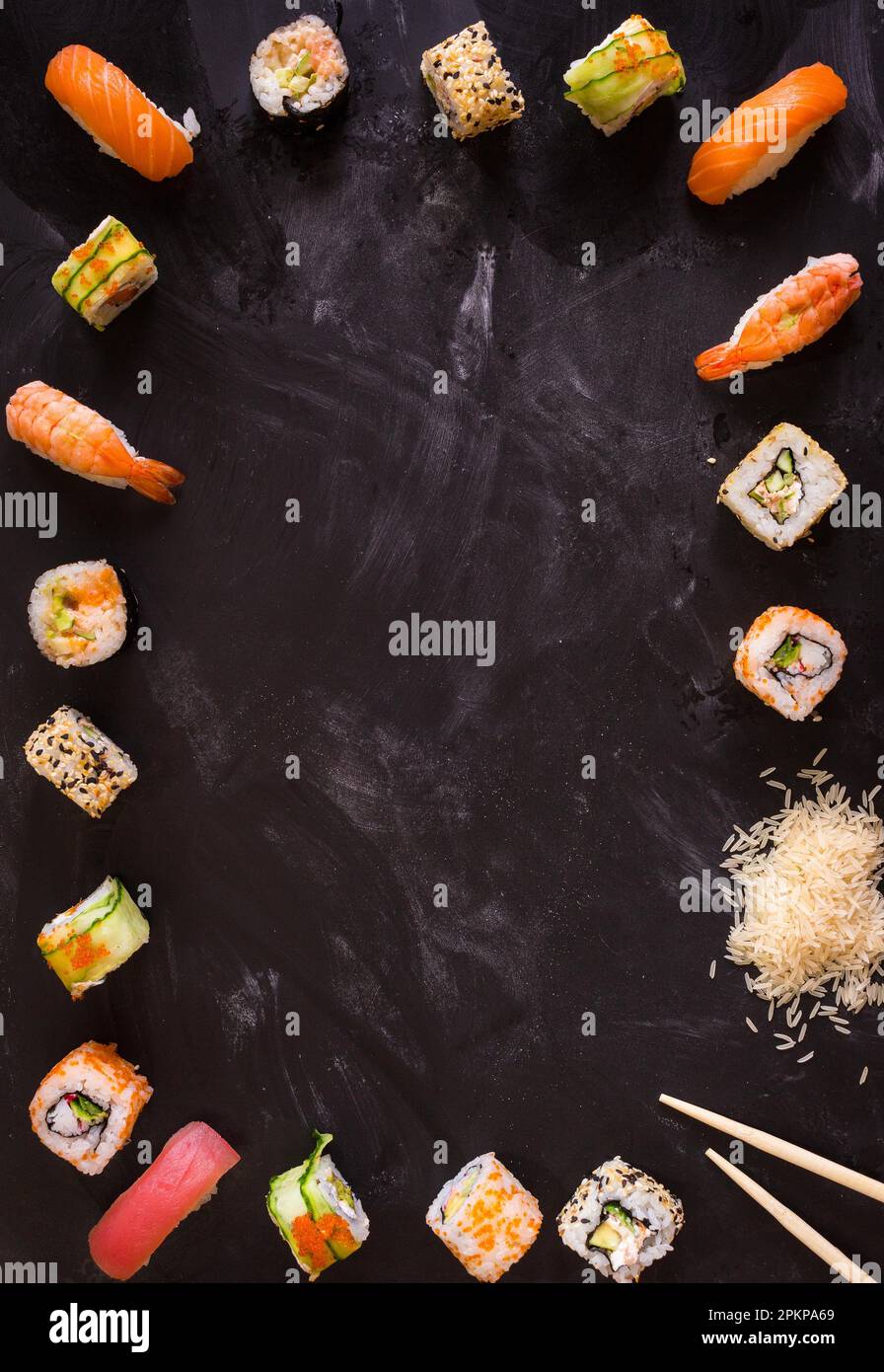 Overhead shot of sushi on dark background. Sushi rolls, nigiri, rice ...