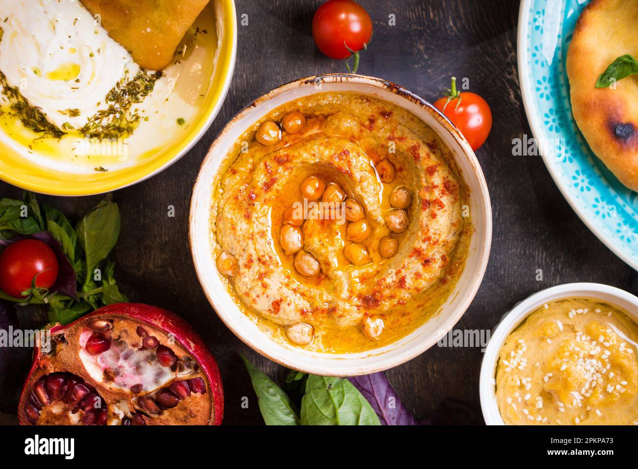 Hummus plate close-up. Hummus, tahini, pitta and buttermilk dip with ...