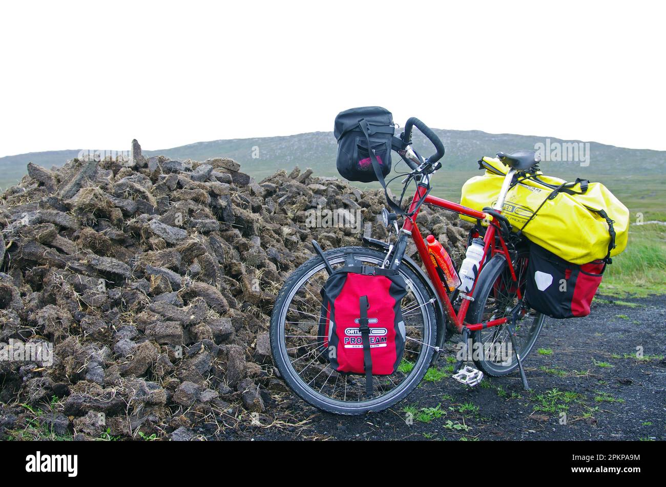 Dried peat sods and packed touring bike, bog, cycle tourism, Connemara ...