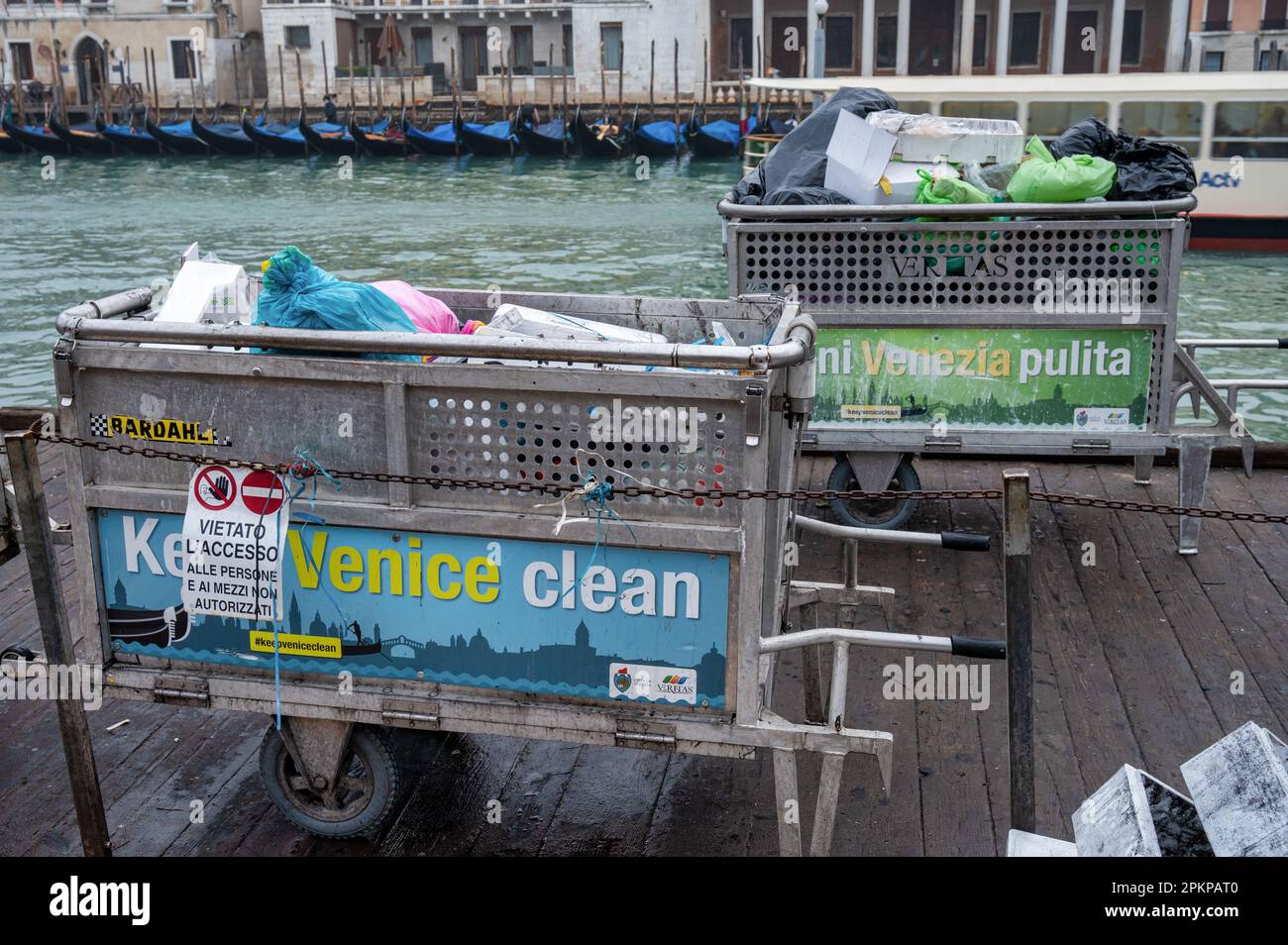 Venice, Italy- Feb 23, 2023: Waste bins filled with trash next to the ...