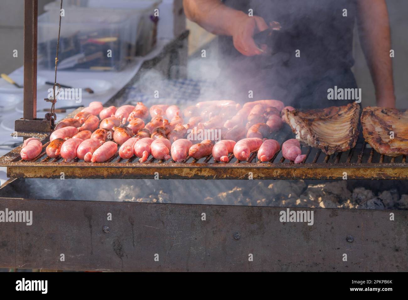 street food, meat tasty grilled sausages, cooking on charcoal in the ...