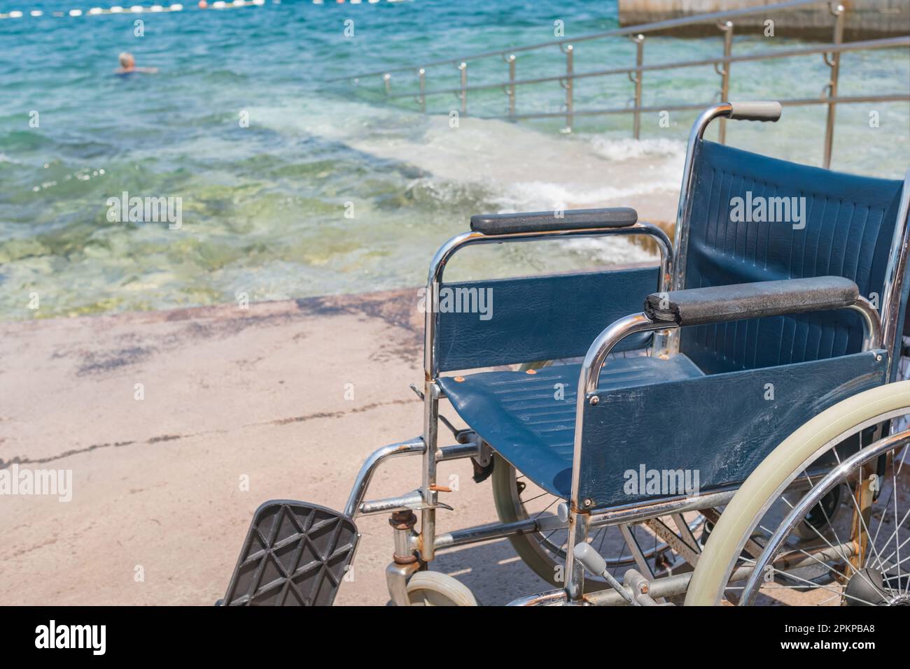 Accessible beach with wheelchair with ramp for persons with disability ...