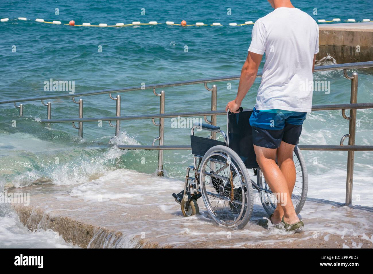 Accessible beach with wheelchair with ramp for persons with disability ...