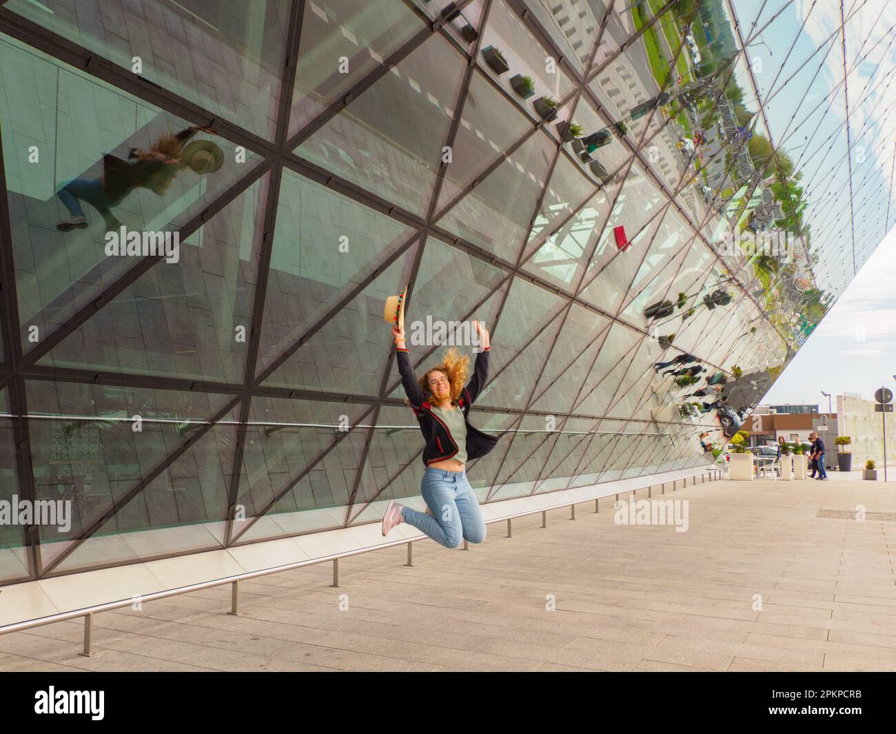 Kraków, Poland - May, 2021: Happy young woman jumps at the ...