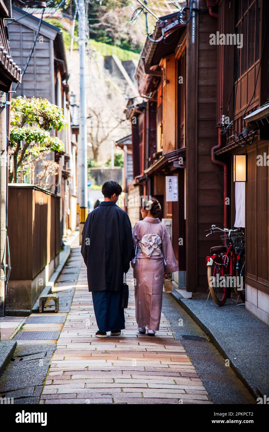 A couple walk through the Higashi Chaya District in Kanazawa, Japan ...