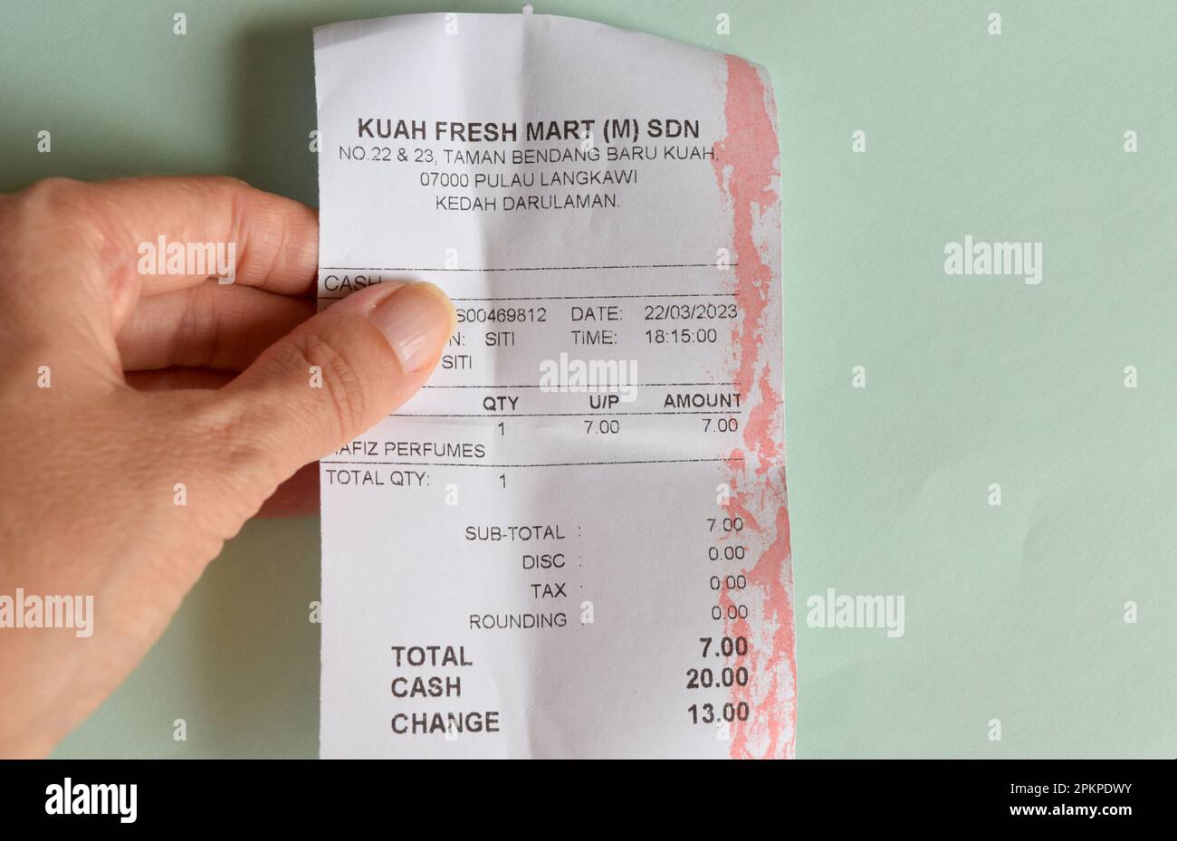 Langkawi Duty Fresh Mart till receipt in hand Stock Photo - Alamy