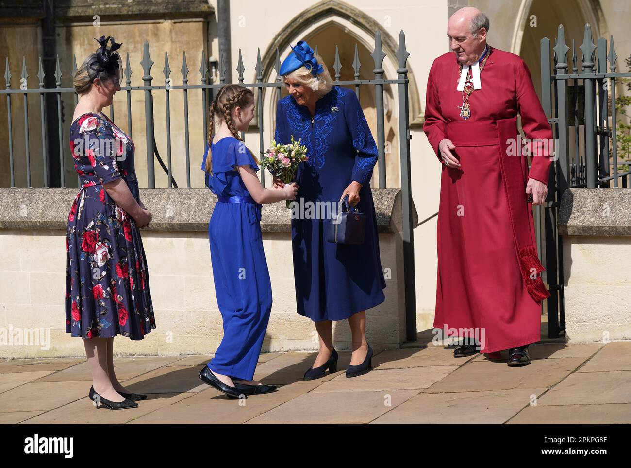 The Queen Consort receives a posy from Harriet, aged 10 after attending ...