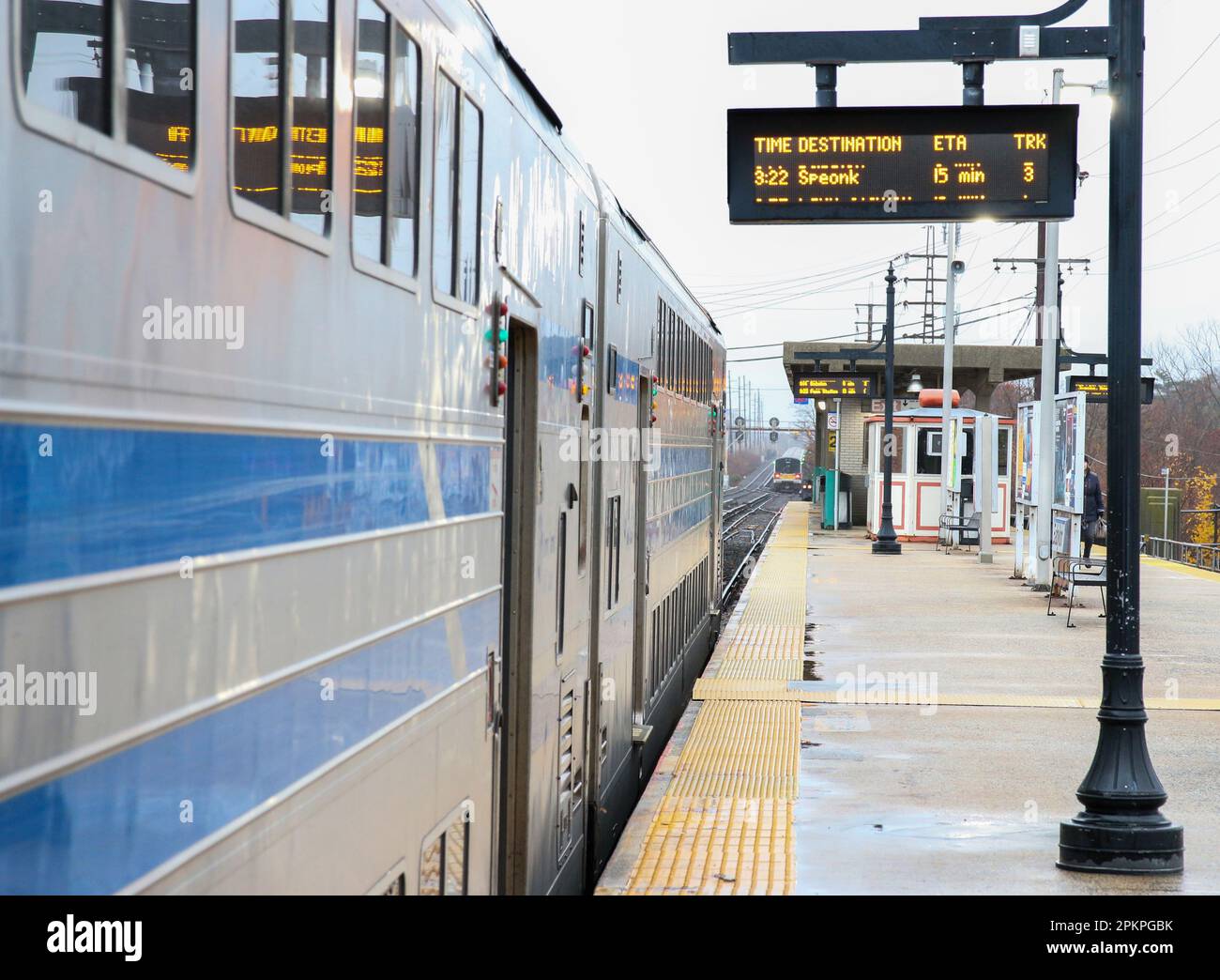A double decker train is heading east leavig the Babylon train station ...