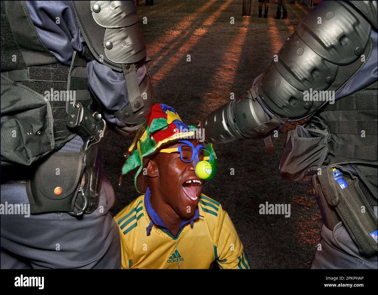 An unruly soccer fan is subdued by riot police outside a stadium in ...