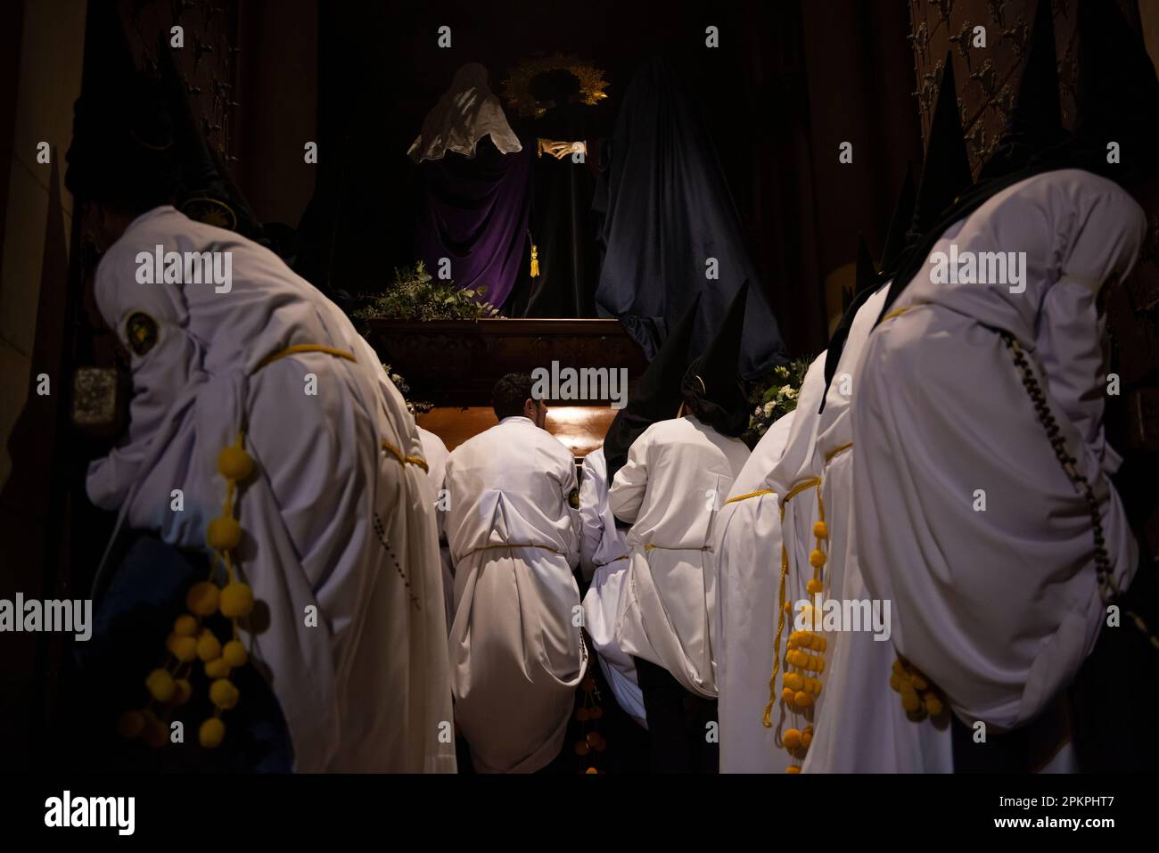 Costaleros lift the titular paso of the procession of Our Lady of ...