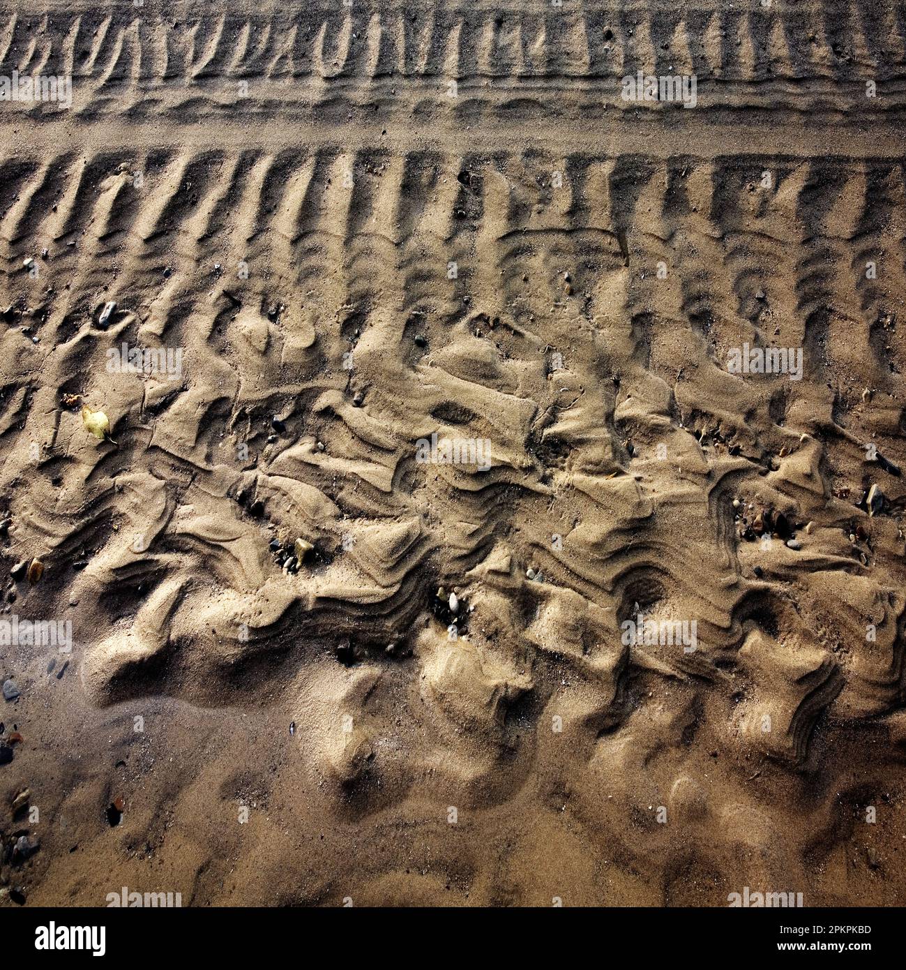 Receding sea water at low tide form interesting sand patters along the ...