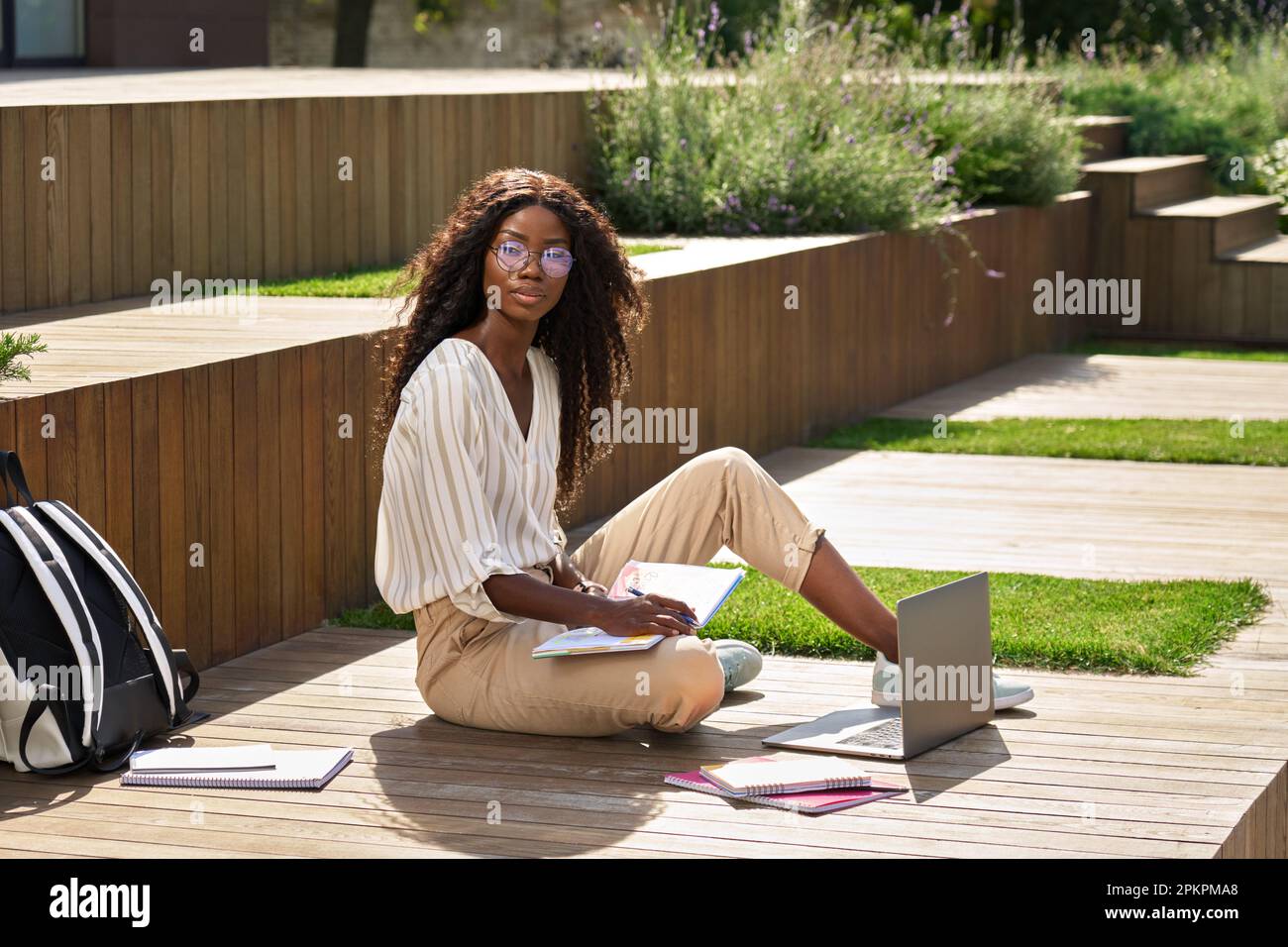 African black girl student elearning outside studying with laptop ...