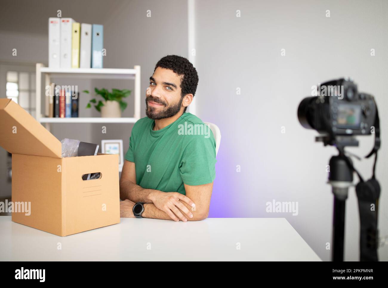 Happy attractive millennial arab guy with beard at workplace with ...