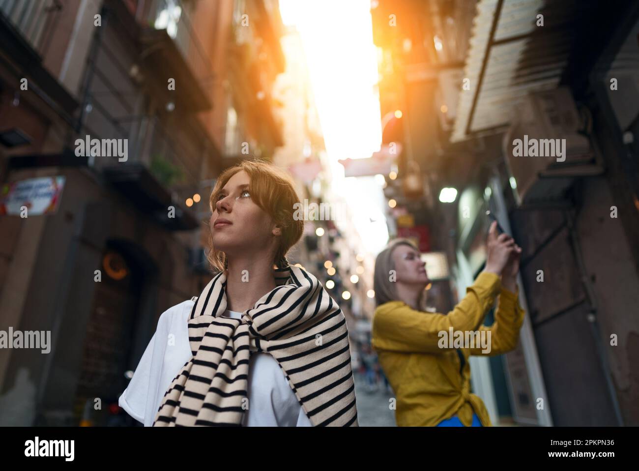 Two female tourists exploring the old town Stock Photo - Alamy