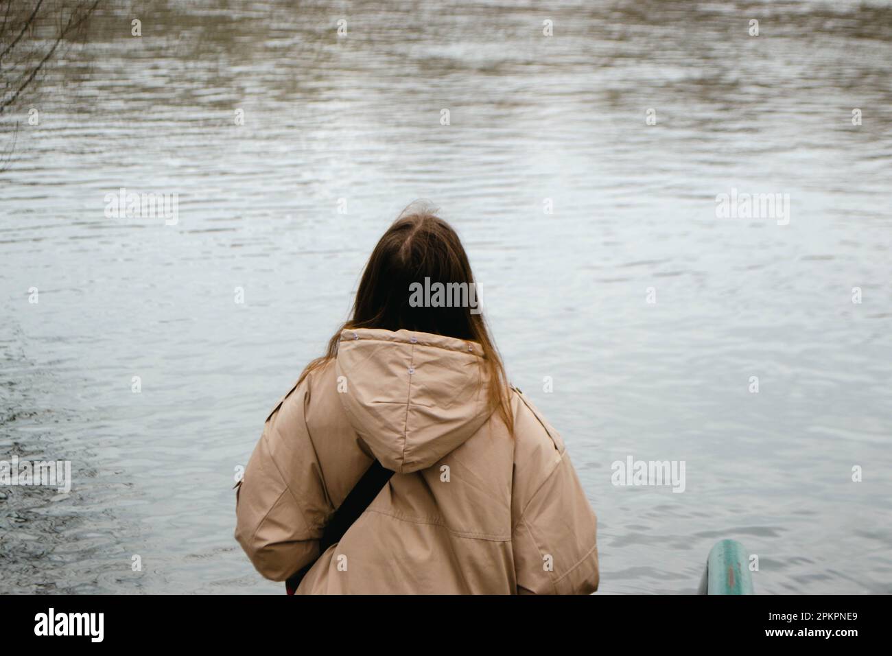 A woman with long brown hair near river in spring. High quality photo ...