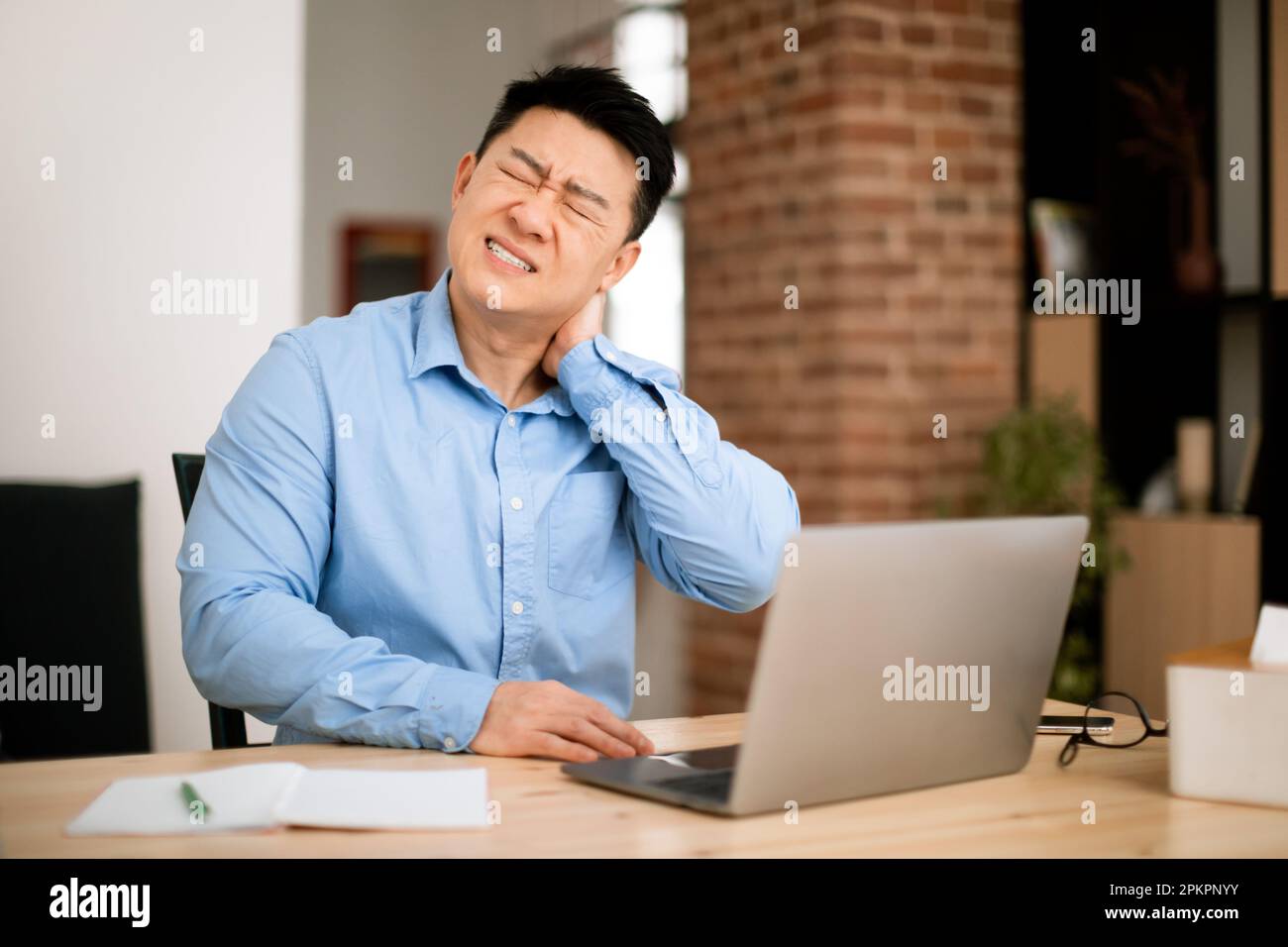Tired stressed asian businessman having neck pain, touching and ...