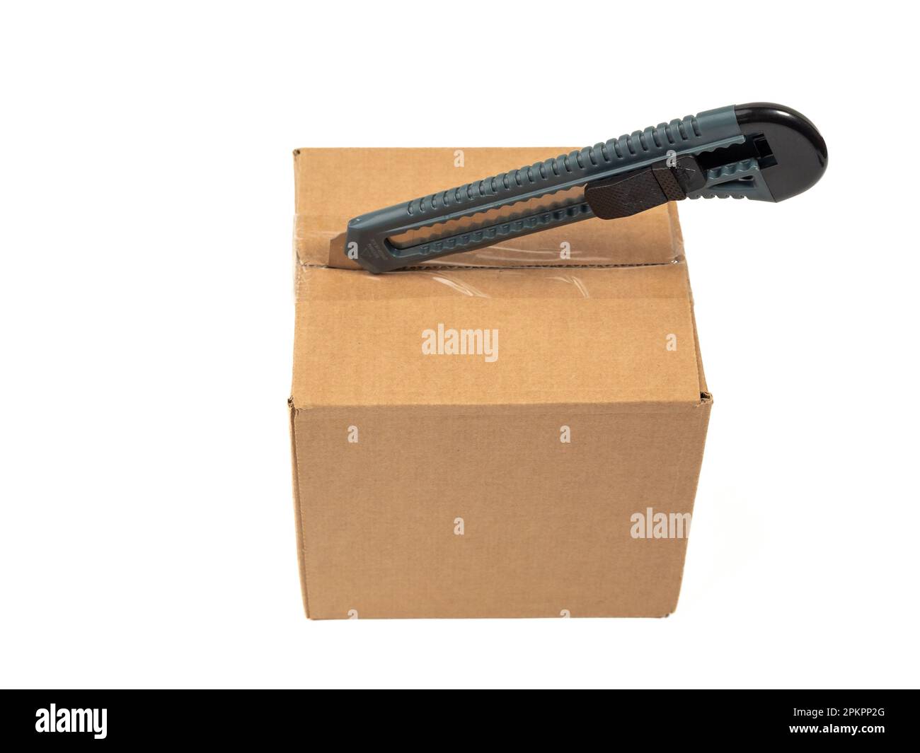 The cardboard box is opened with a knife. White background Stock Photo ...