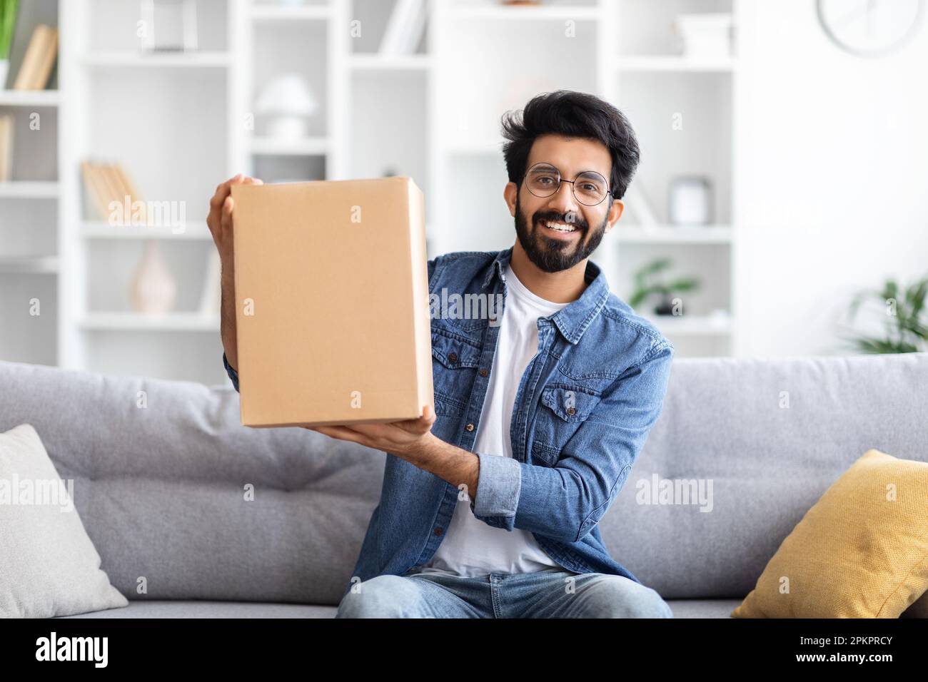 Handsome Young Indian Man Demonstrating Cardboard Box With Delivery At ...