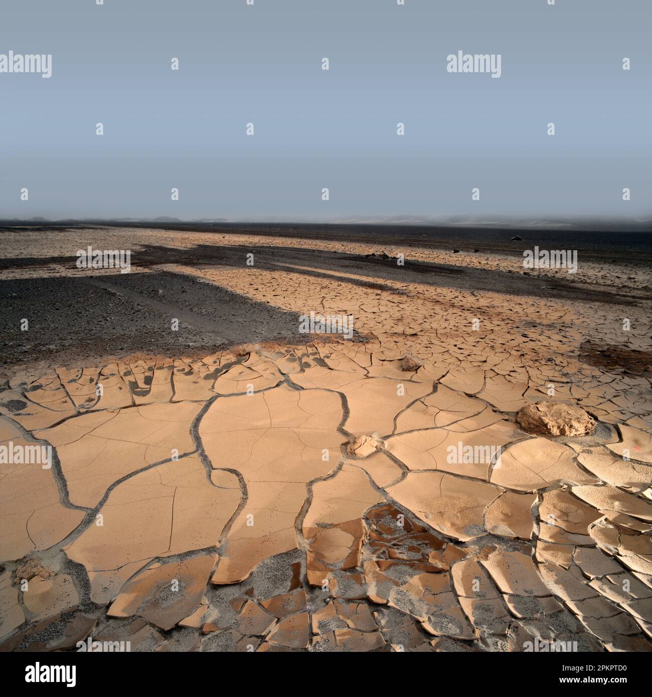 Light of the setting sun hits the barren landscape of the northern ...