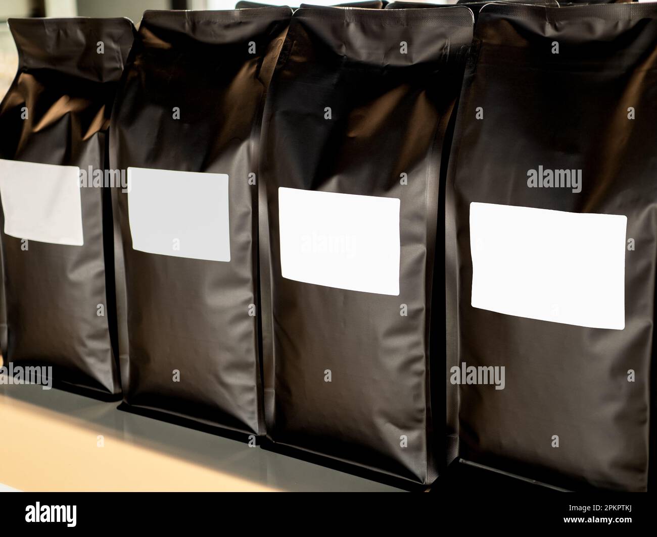 Close Up empty blank white label on modern black bag coffee beans ...