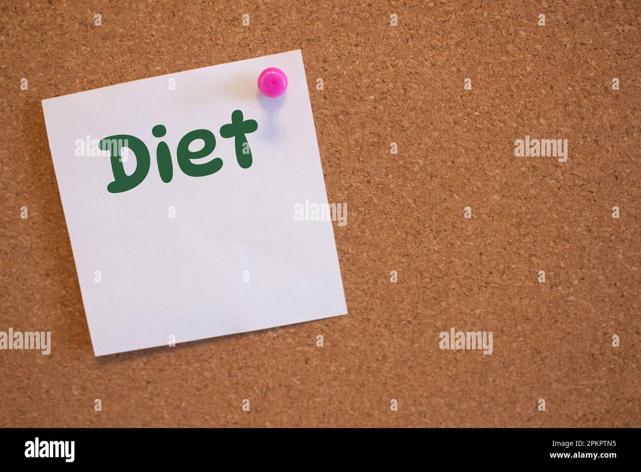 White square sticker with a diet note pinned to a cork board Stock ...